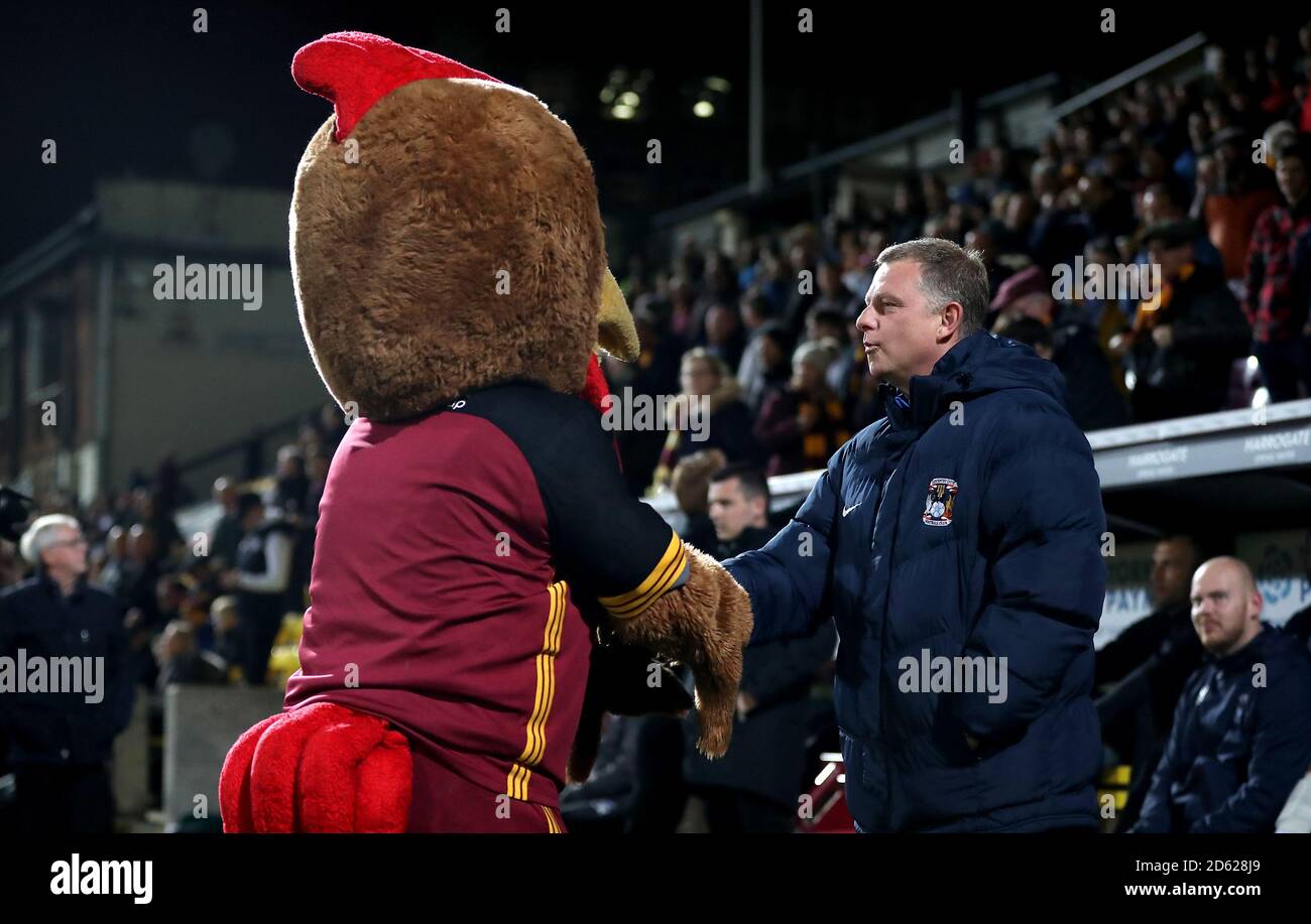 Coventry City manager Mark Robins (right) with the Bradford City mascot ...