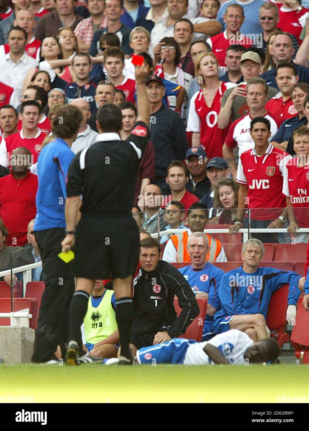 Middlesbrough's George Boateng (on floor)is shown the red card by ...