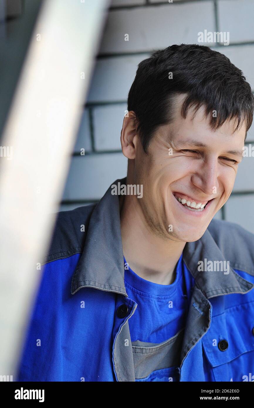 A cheerful and happy employee smiles at the workplace Stock Photo - Alamy