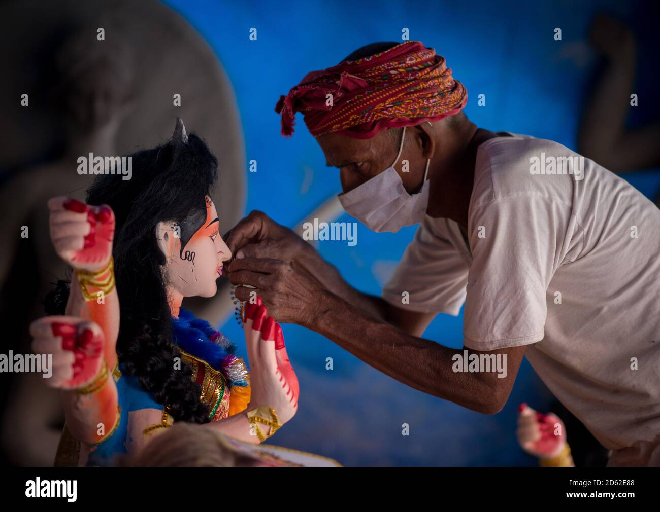 Lalitpur, Nepal. 14th Oct, 2020. An artist gives a final touch to a ...