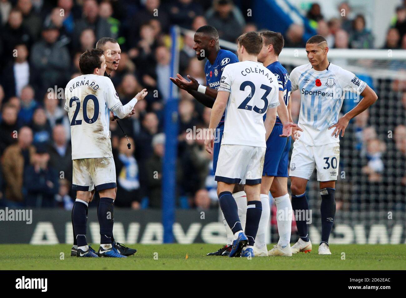 Match referee Kevin Friend gives a yellow card to Chelsea's Antonio ...