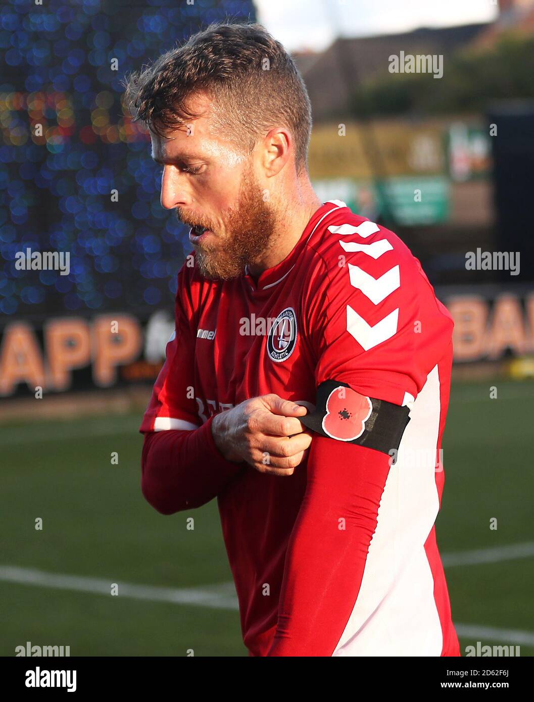 Charlton Athletic's Billy Clarke gives his poppy arm band to a fan ...