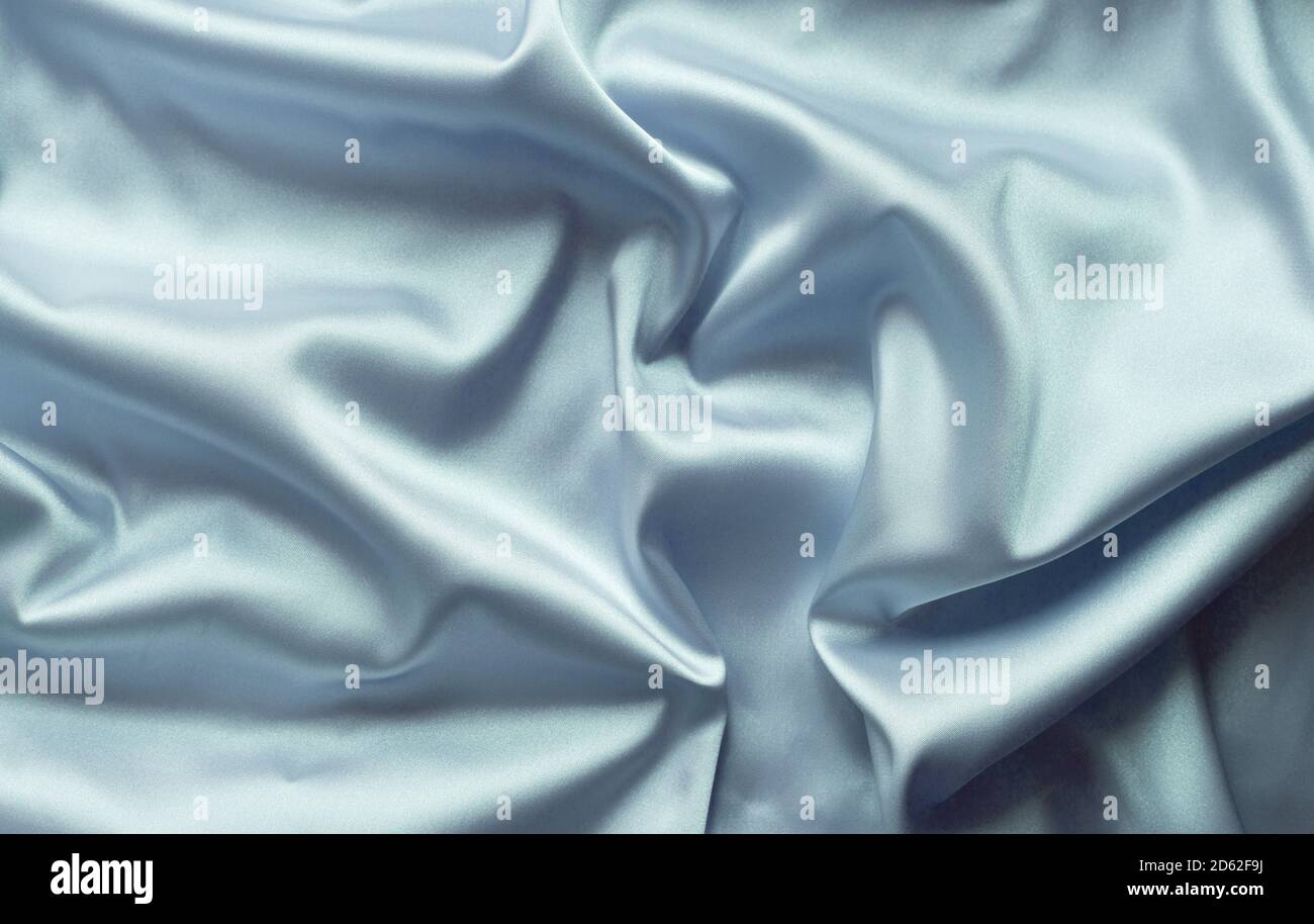 Smooth elegant blue silk with soft folds can be used as background ...