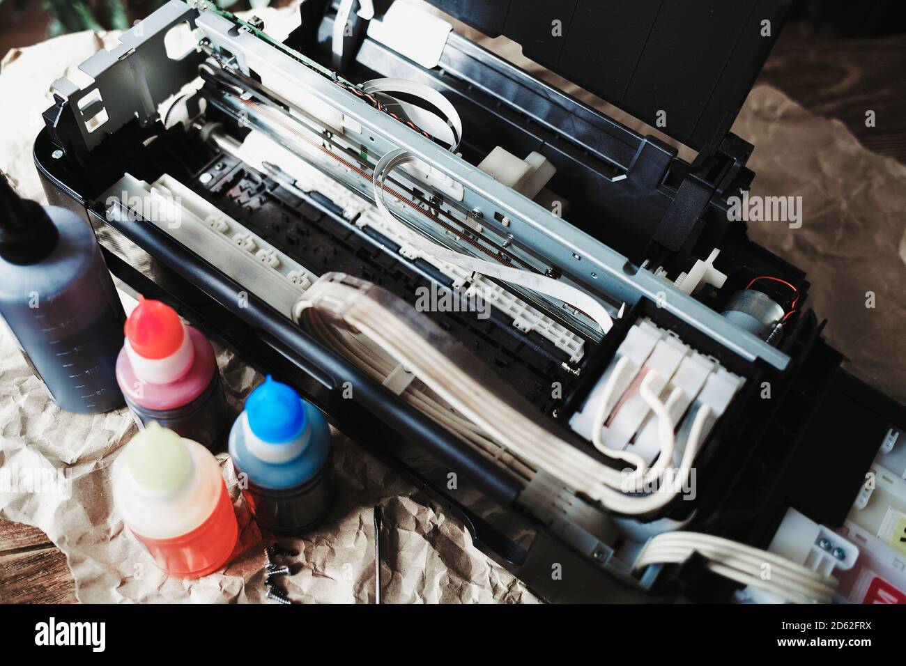 Refilling printer cartridges with multi-colored ink. Background Stock ...