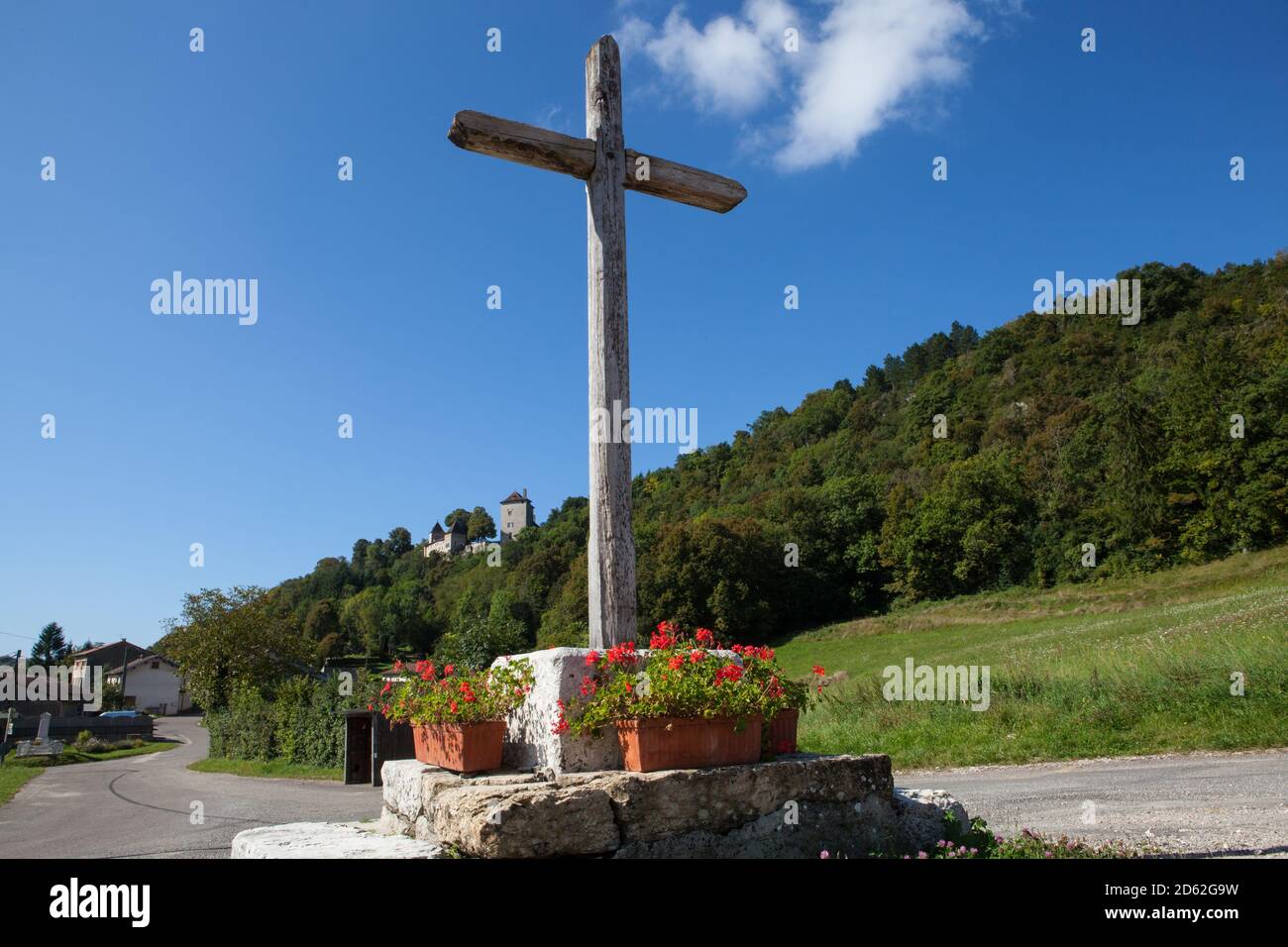 Low angle shot of a wooden cross on a clear sky and a mountain ...