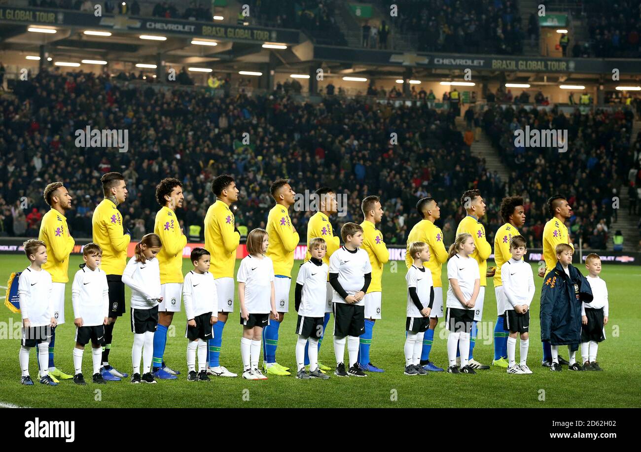 Brazil players line-up before kick-off to sing their national anthem ...