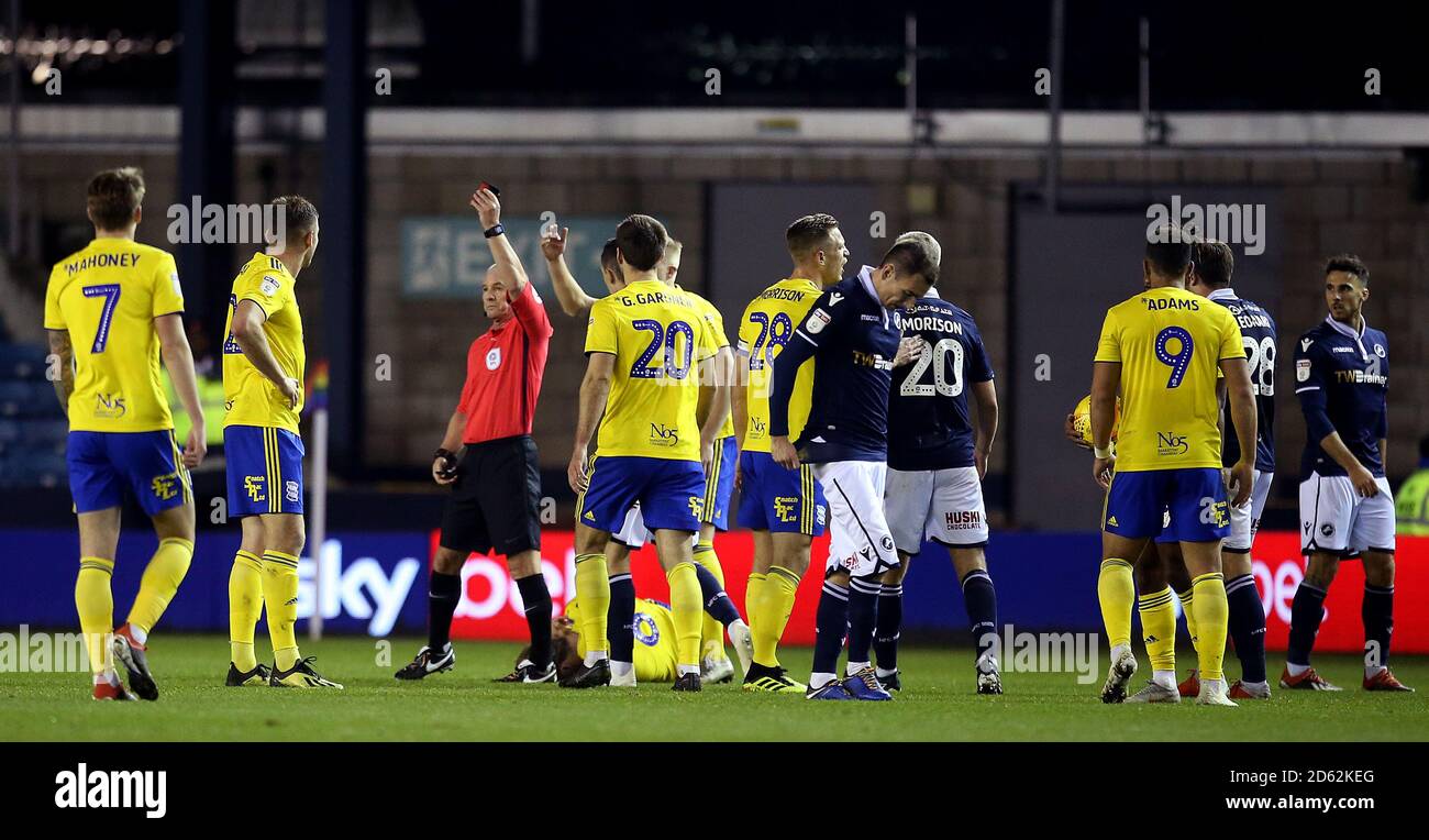 Millwall's Ryan Leonard is shown a red card by referee Mr Scott Duncan ...