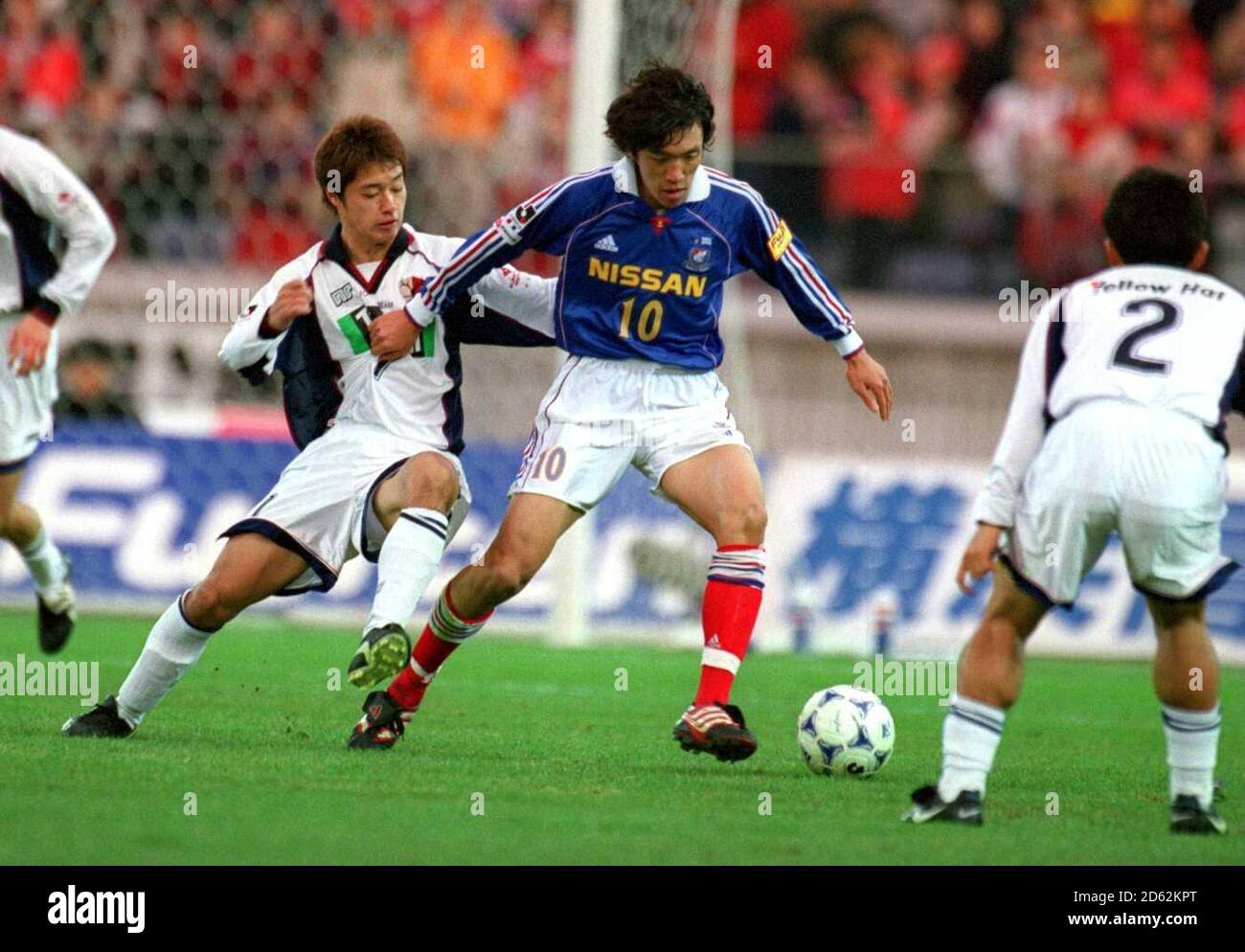 Yokohama Marinos' Syunsuke Nakamura (r) holds off Kashima Antlers ...