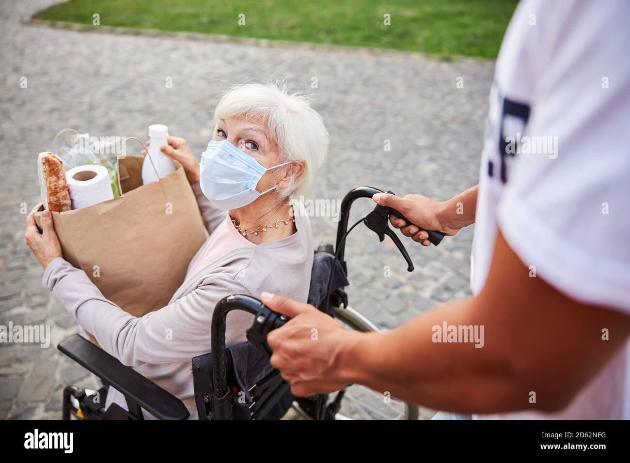 Curious lady looking at the person helping her during the pandemic ...