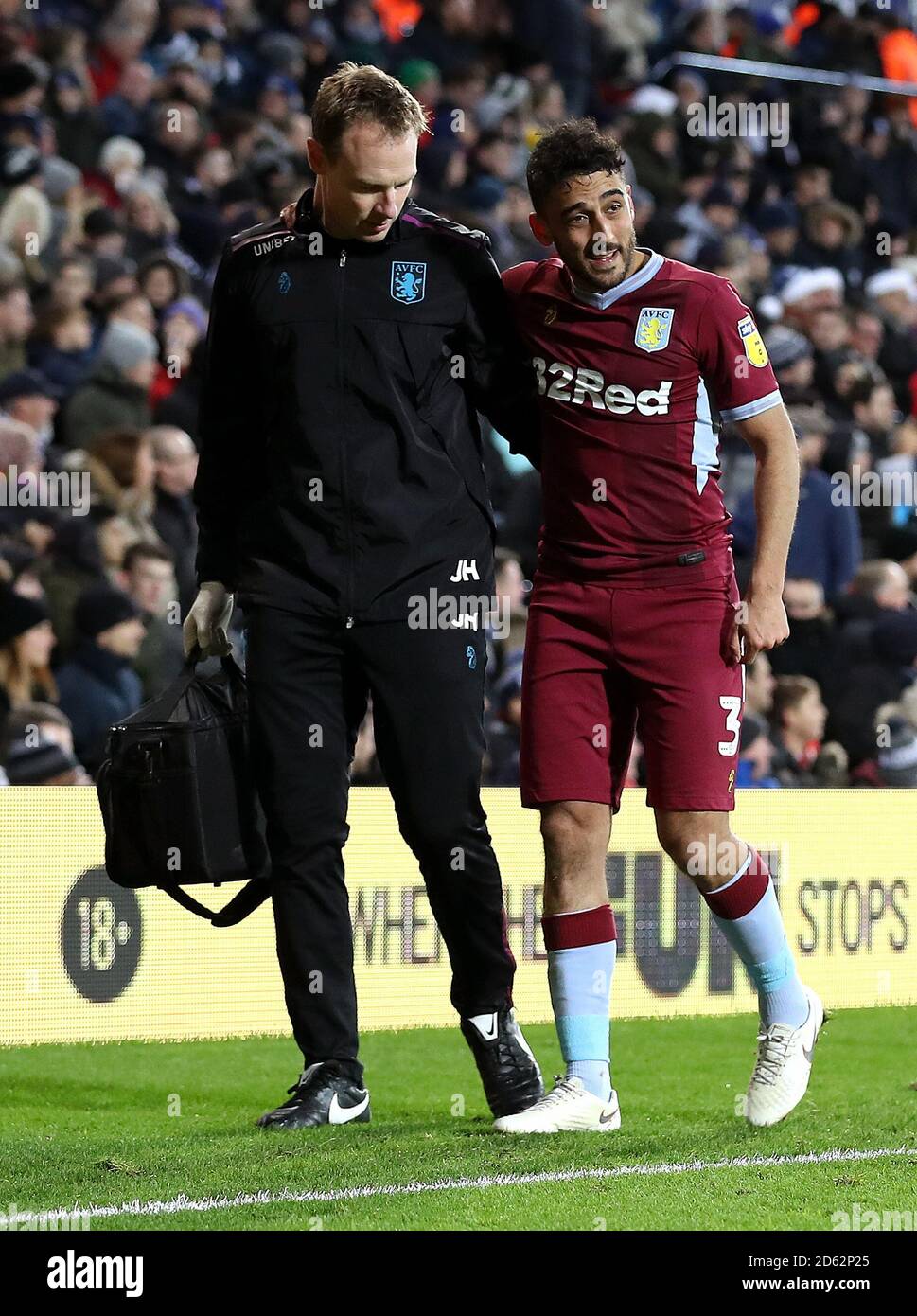 Aston Villa's Neil Taylor (right) leaves the pitch with an injury Stock ...