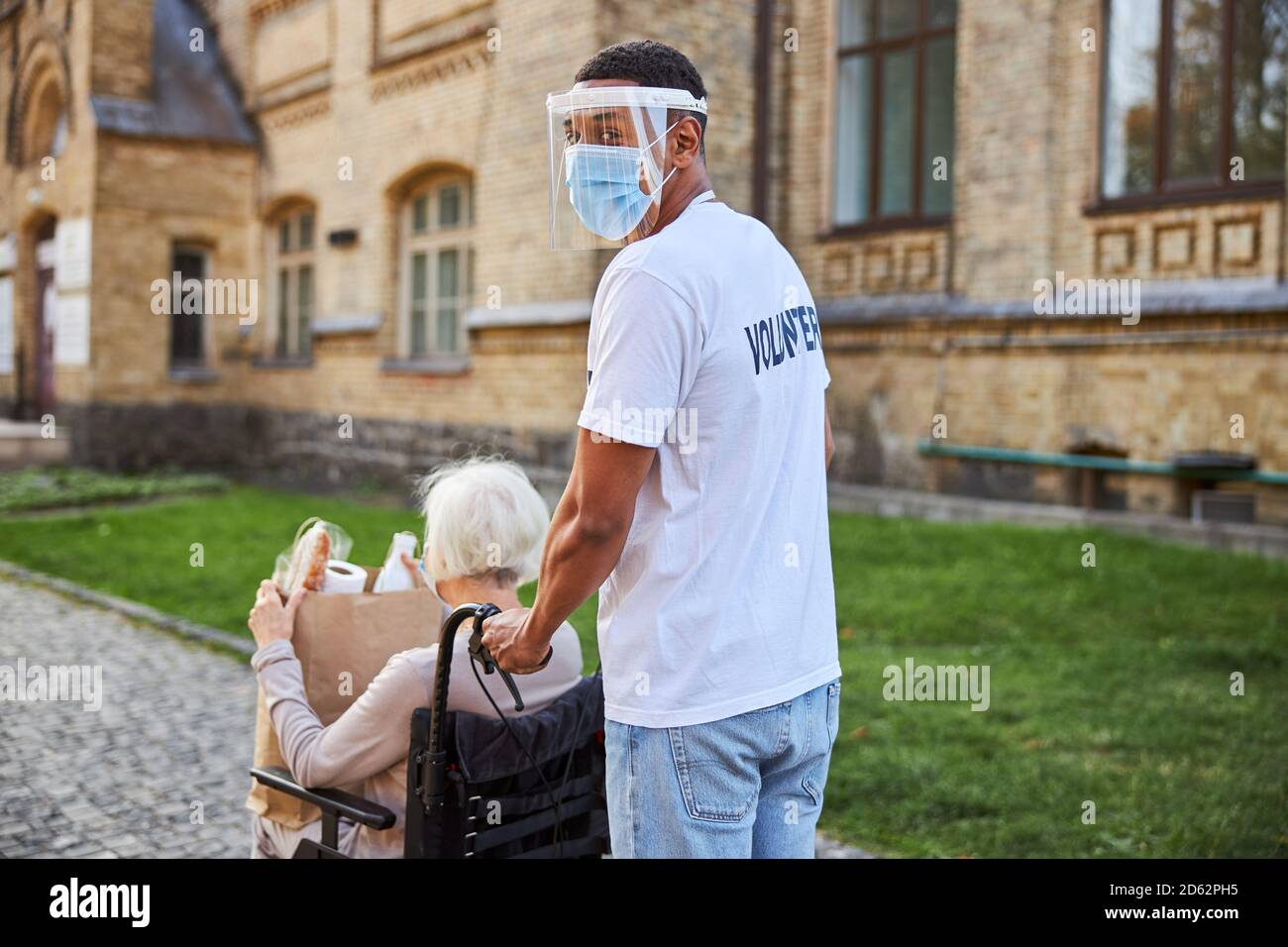 Using protective shield and mask while working with elderly people ...