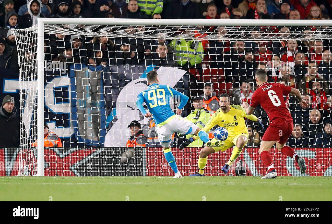 Liverpool goalkeeper Alisson Becker (centre) makes a save from Napoli's ...