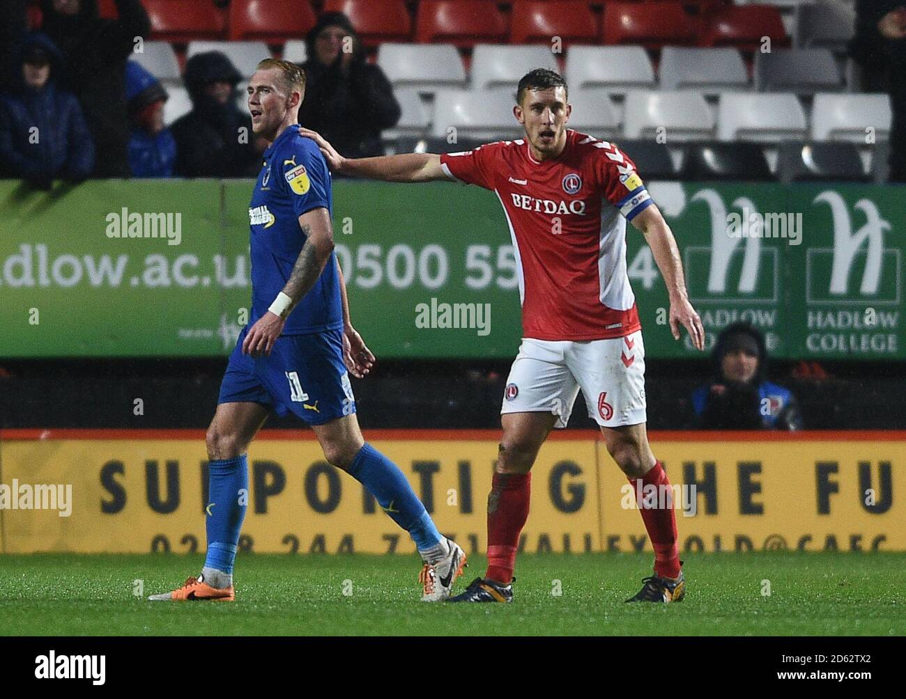 Charlton Athletic's Jason Pearce (right) encourages AFC Wimbledon's ...
