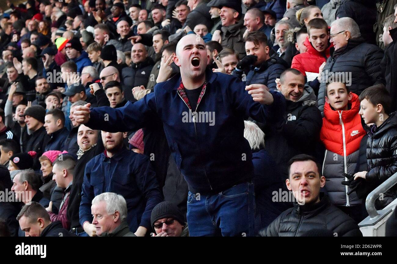 Fans in the stand react Stock Photo - Alamy