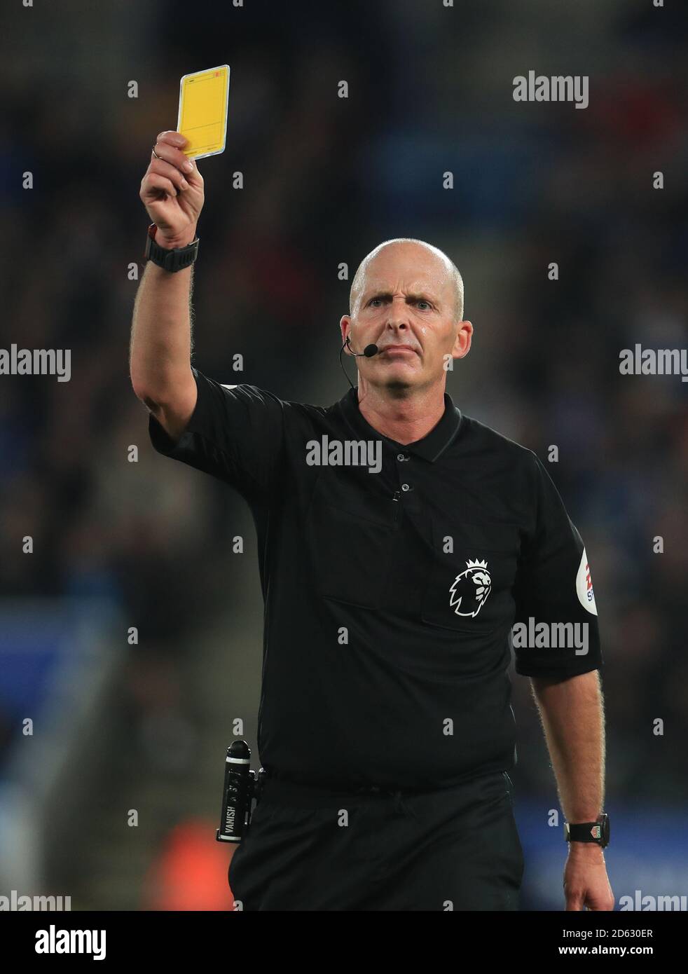 Referee Mike Dean gives a yellow card Stock Photo - Alamy