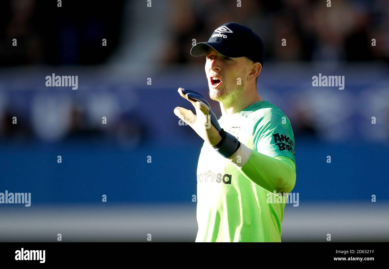 Everton goalkeeper Jordan Pickford wears a baseball cap to shield his ...