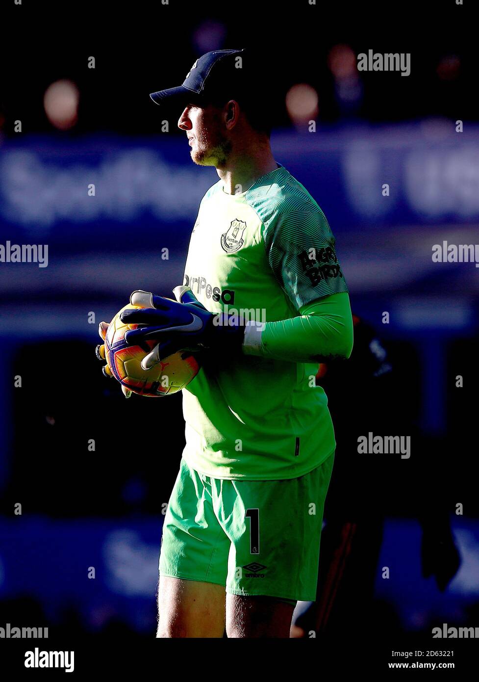 Everton goalkeeper Jordan Pickford wears a baseball cap to shield his ...