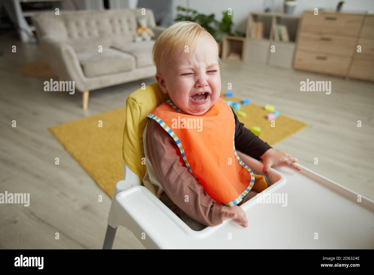 Toddler crying in chair hi-res stock photography and images - Alamy