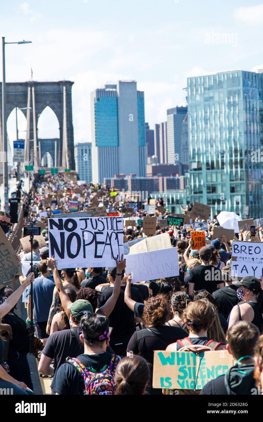 Crowd of Protesters with Signs Marching across Brooklyn Bridge during ...