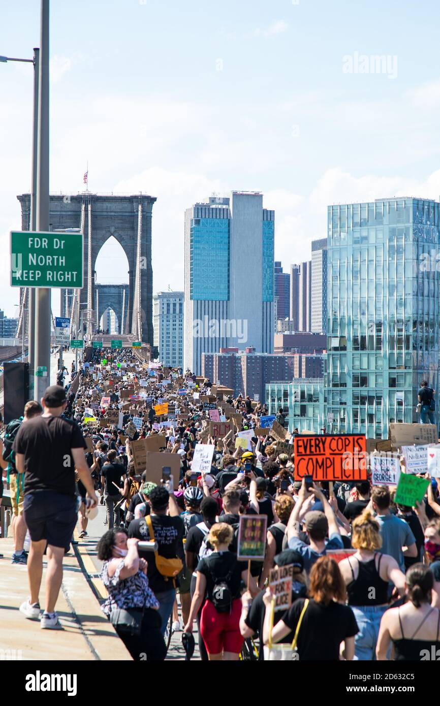 Crowd of Protesters with Signs Marching across Brooklyn Bridge during ...