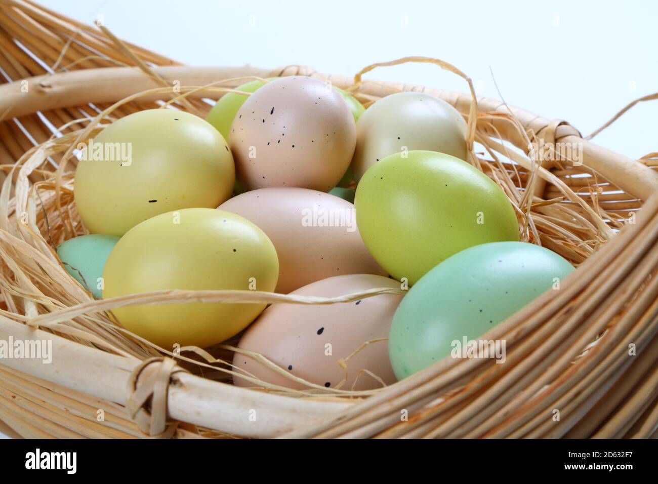 Easter colored eggs in basket Stock Photo - Alamy