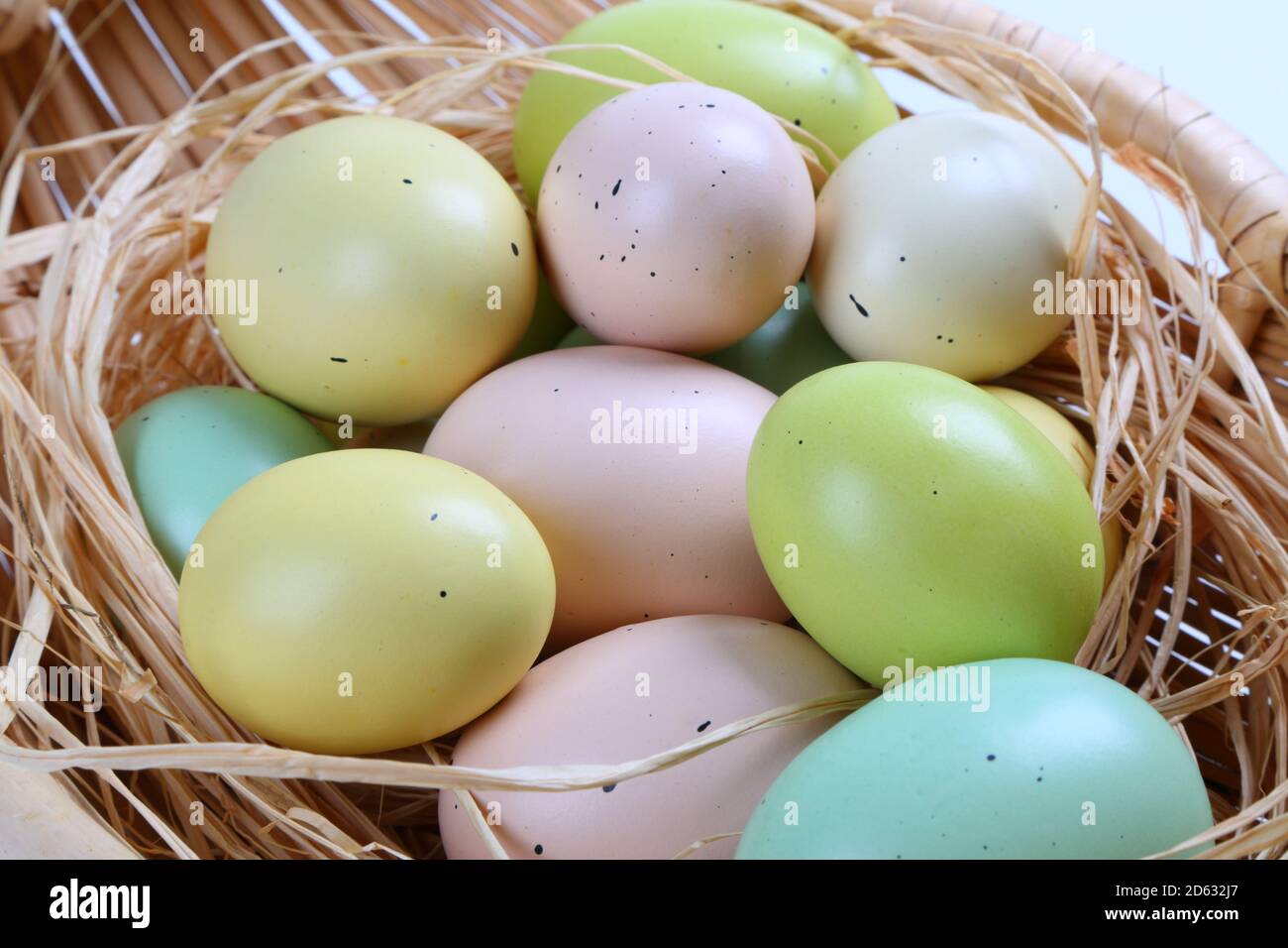 Easter colored eggs in basket Stock Photo - Alamy