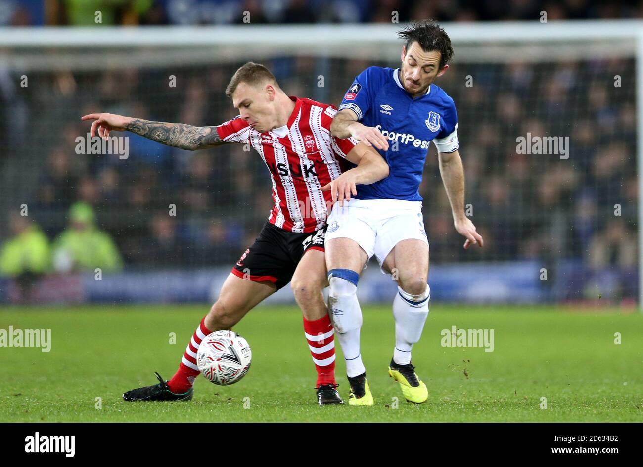 Lincoln City's Harry Anderson (left) and Everton's Leighton Baines ...