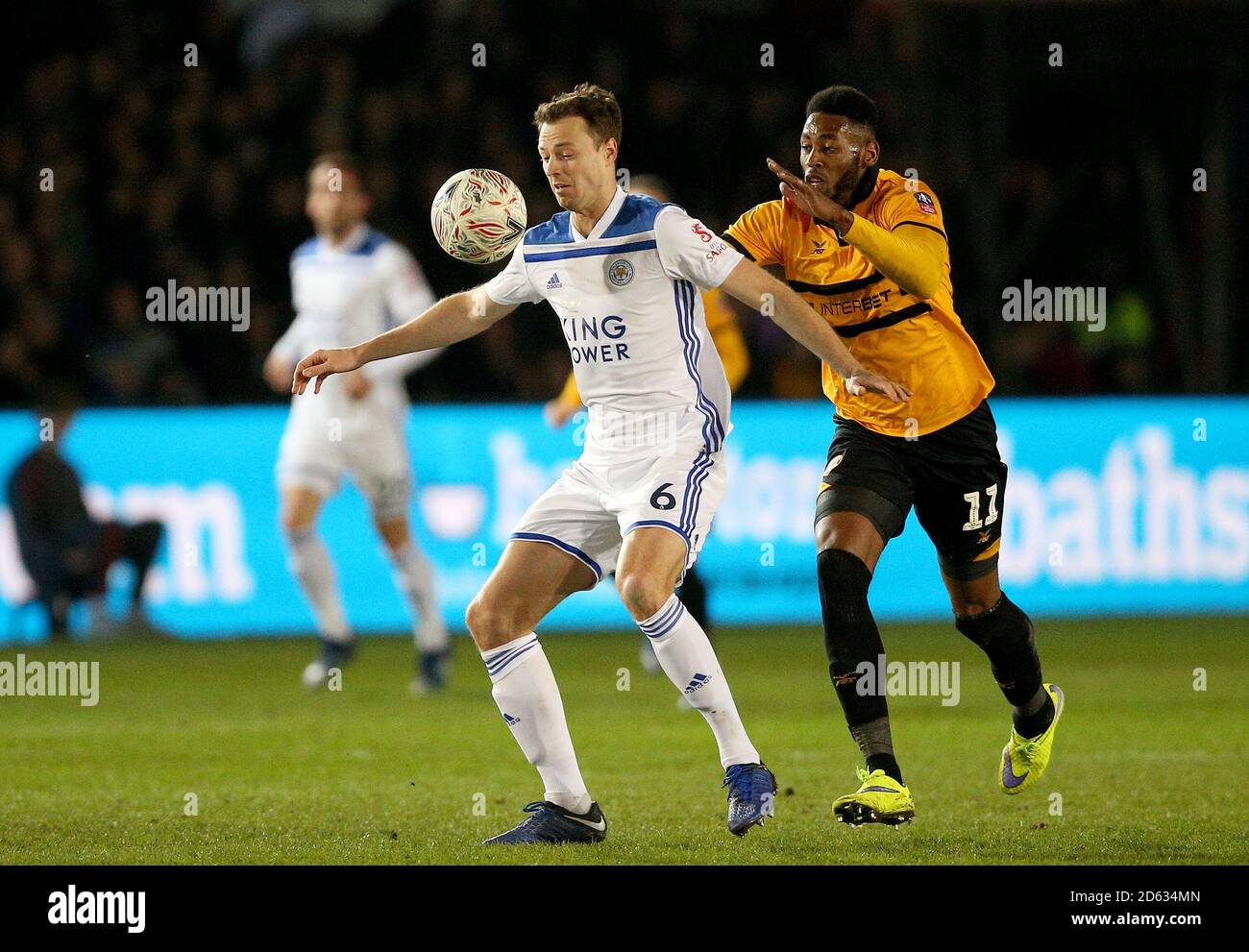 Leicester City's Jonny Evans (left) and Newport County's Jamille Matt ...