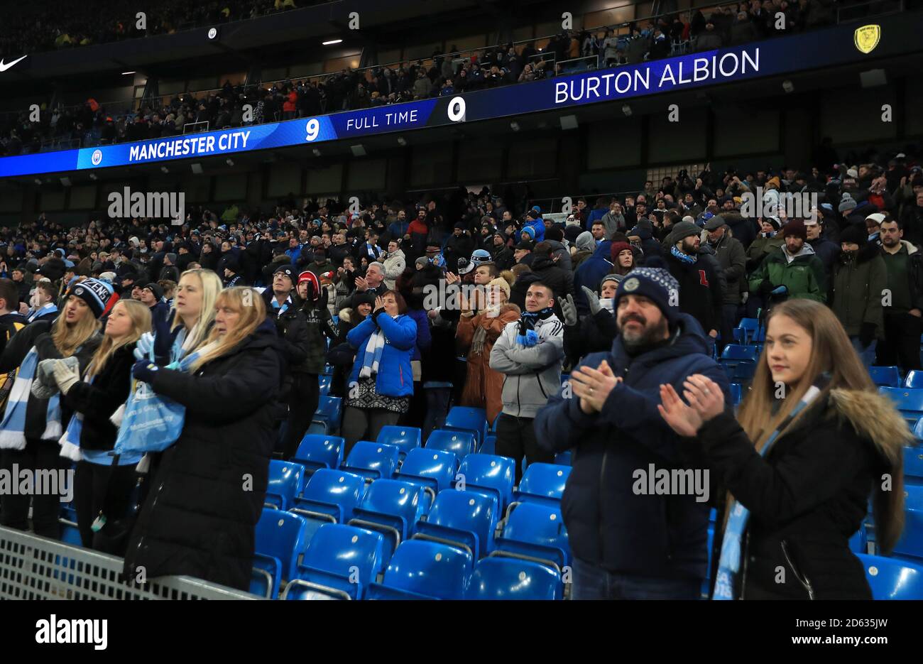 The scoreboard shows the scoreline as Manchester City fans applaud ...