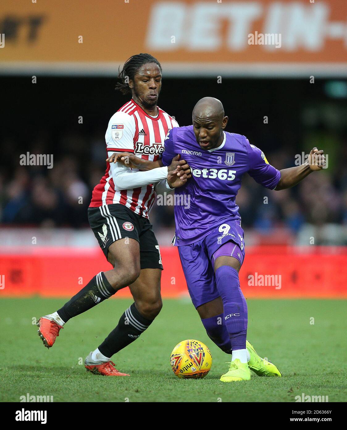 Brentford's Romaine Sawyers (left) and Stoke City's Benik Afobe battle ...