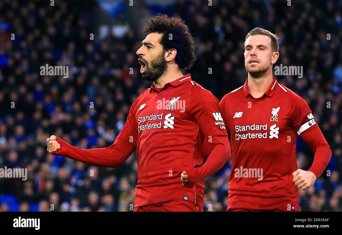Liverpool's Mohamed Salah (left) celebrates scoring his side's first ...