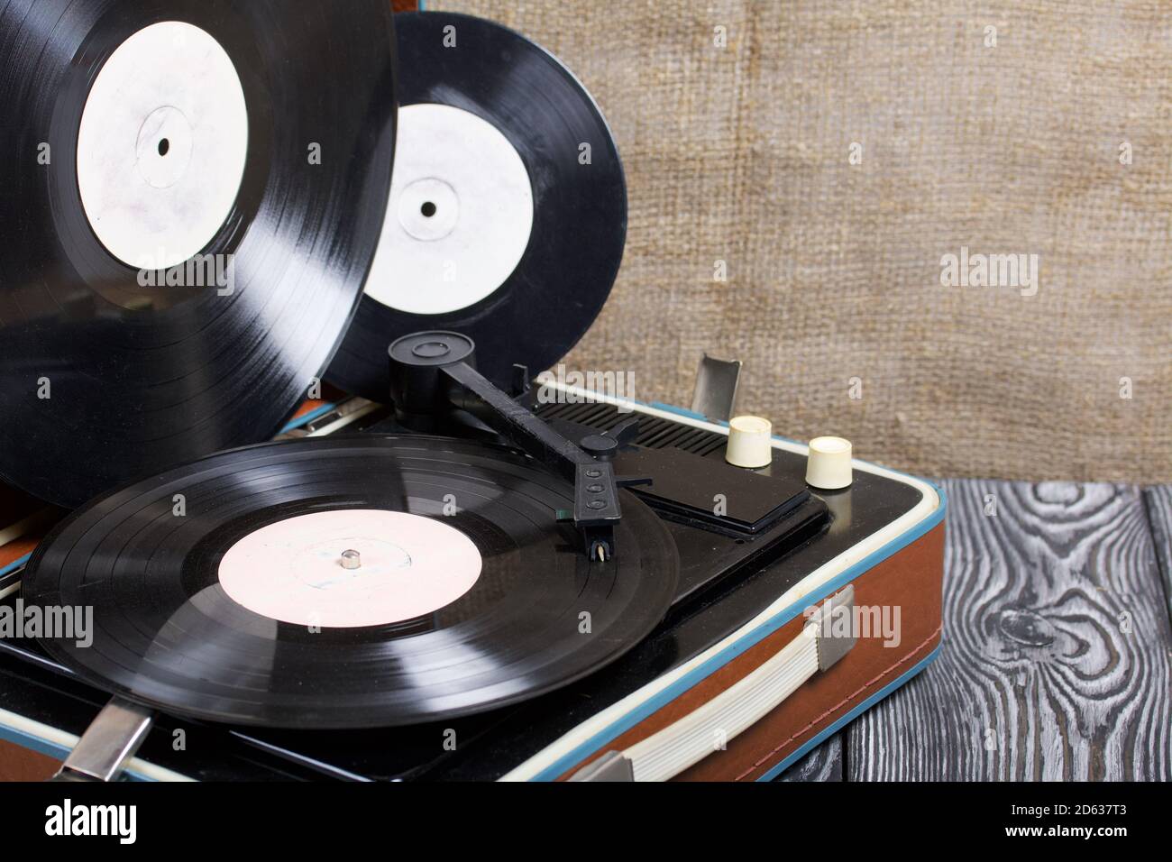 Old turntable. Several vinyl records are nearby. Retro party equipment ...