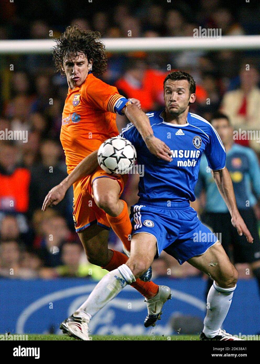 Barcelona's Carles Puyol and Chelsea's Andriy Shevchenko battle for the ...
