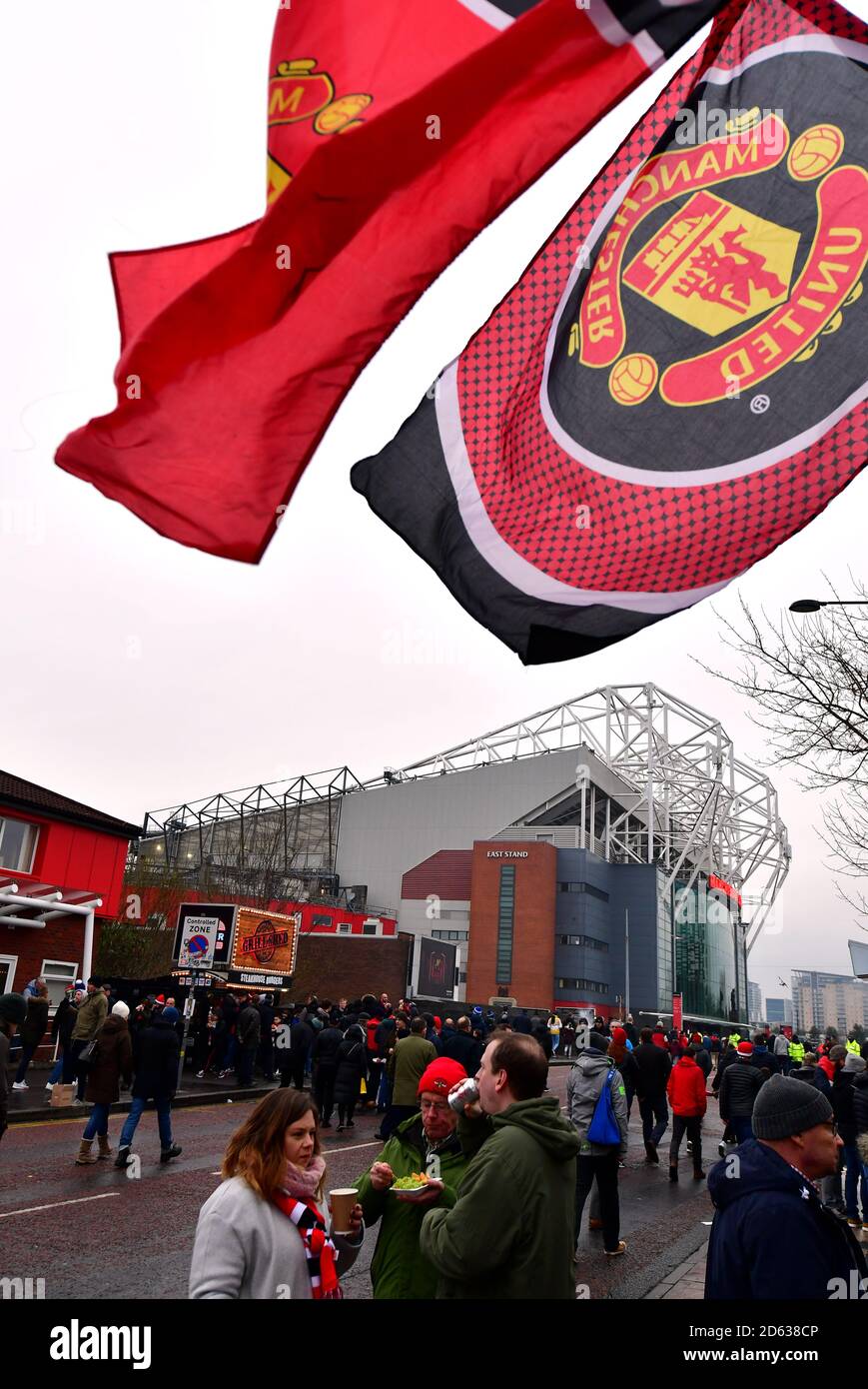 Fans and Manchester United flags outside the ground Stock Photo - Alamy