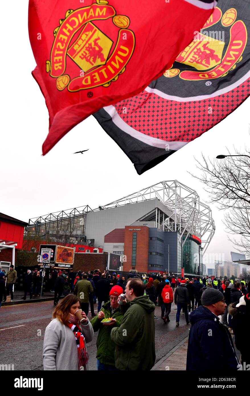 Fans and Manchester United flags outside the ground Stock Photo - Alamy