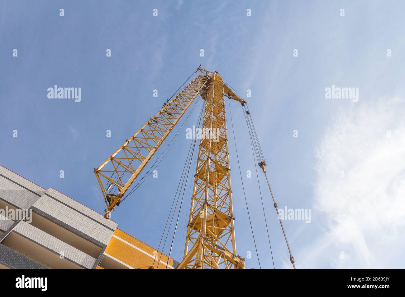 Tower crane at a construction site. Lowered tower crane on sky ...