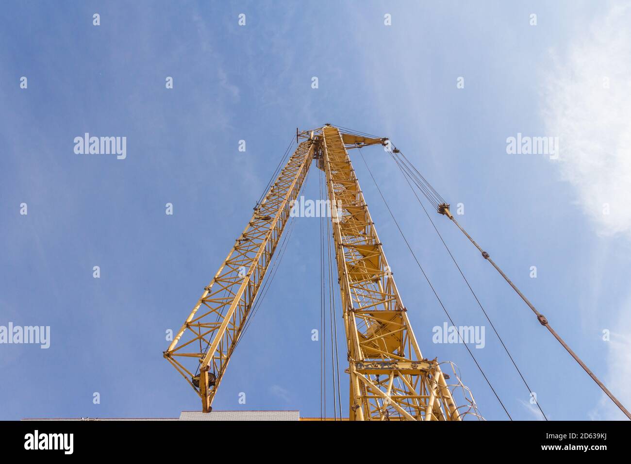 Tower crane at a construction site. Lowered tower crane on sky ...