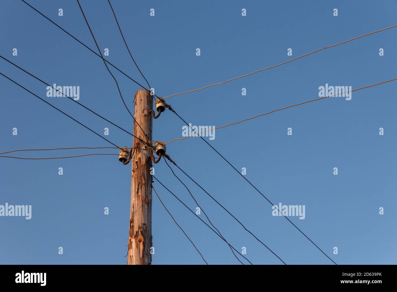 Closer look of the electric post with the big wires on it. Post with ...
