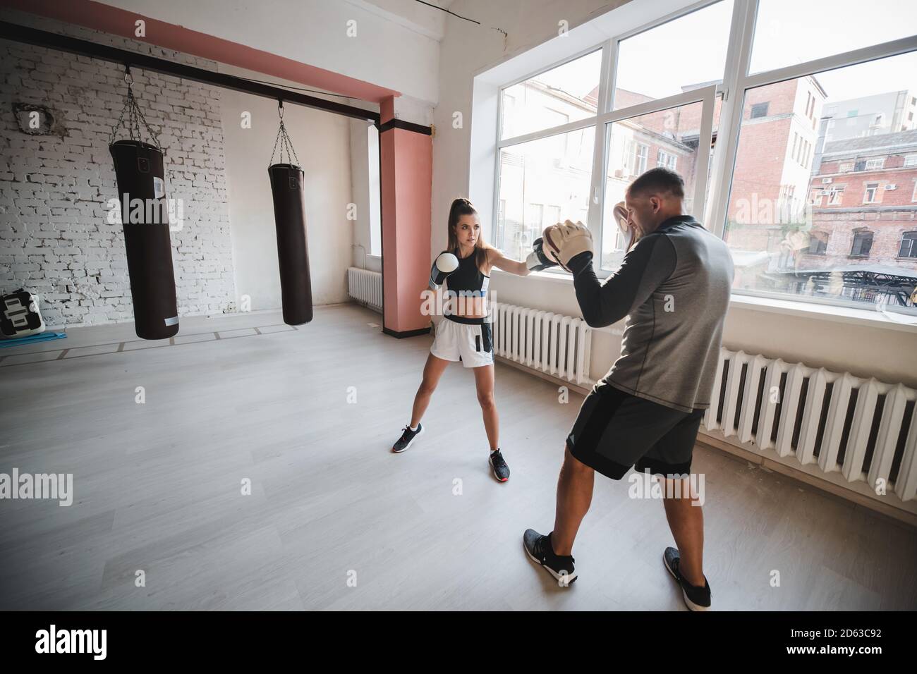 A man and a woman sparring partners train in the fighters training hall ...
