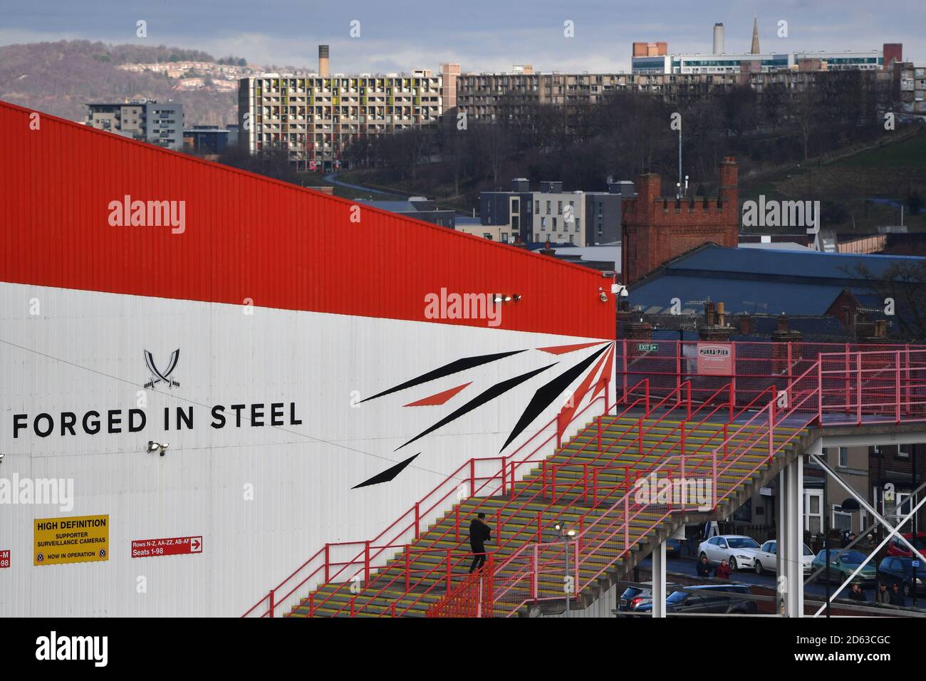 A fan climbs the steps of the top stand Stock Photo - Alamy