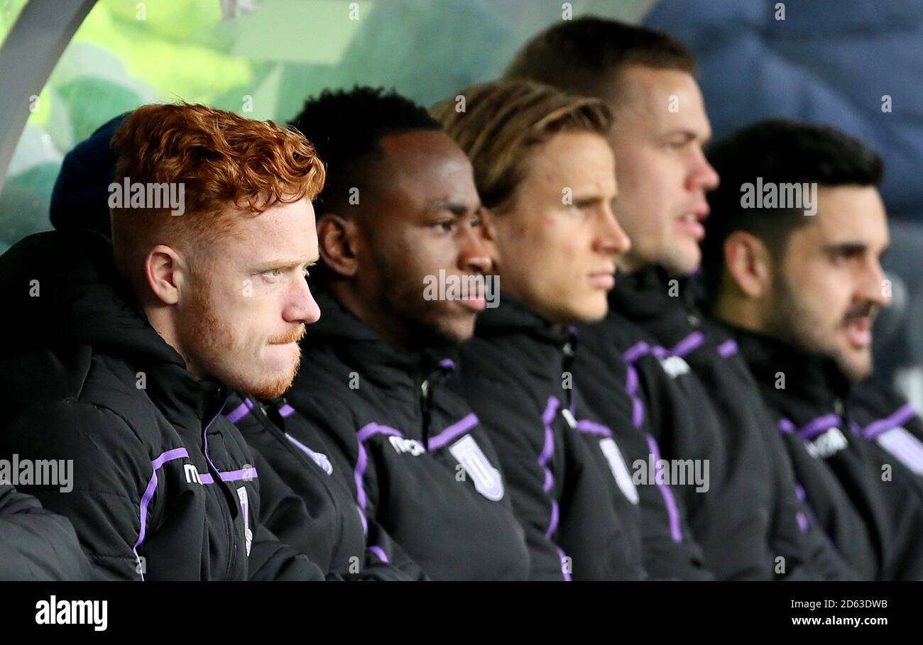 Stoke City's Ryan Woods (left) and team-mates on the substitute's bench ...