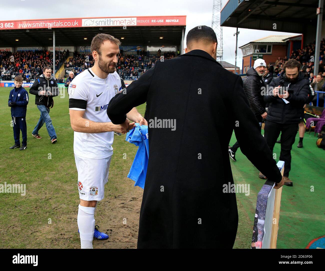 Rochdale's Joe Thompson recieves a signed shirt from Coventry City's ...