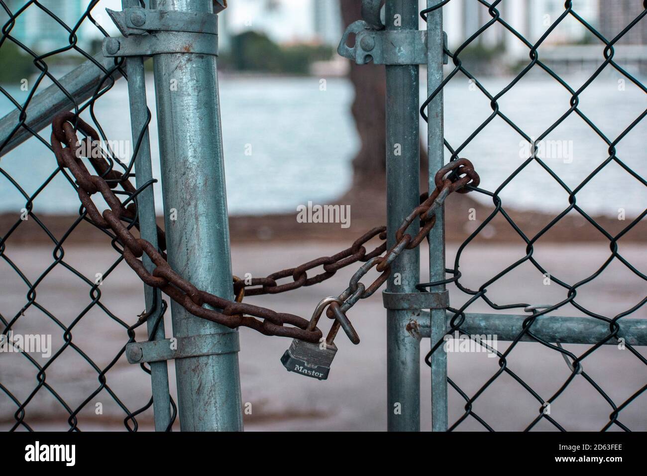 Padlock closing a beach fence Stock Photo - Alamy