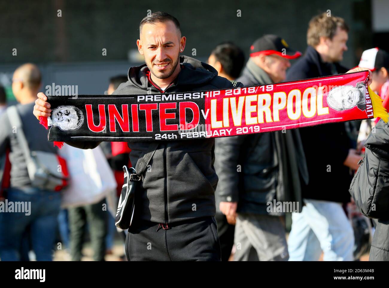Fans pose with half and half scarf ahead of the match Stock Photo - Alamy
