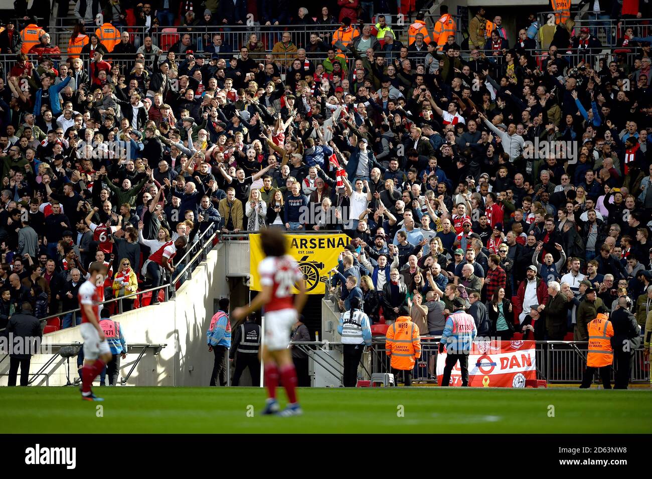 Arsenal fans celebrate in the stands after Aaron Ramsey scores his side ...