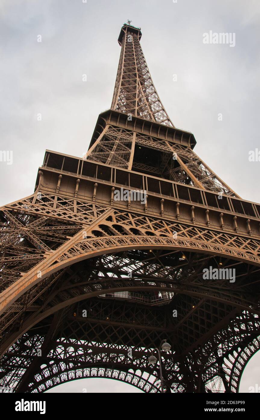 View of the Eiffel Tower from below on a cloudy day. Paris, France ...