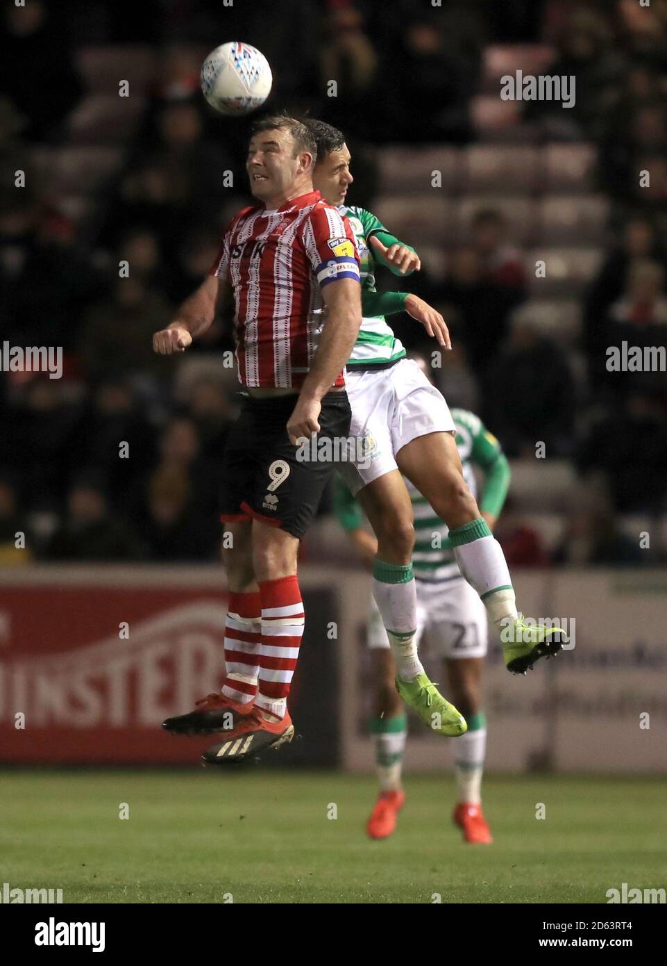 Lincoln City's Matt Rhead (left) and Yeovil Town's Cortney Duffus ...