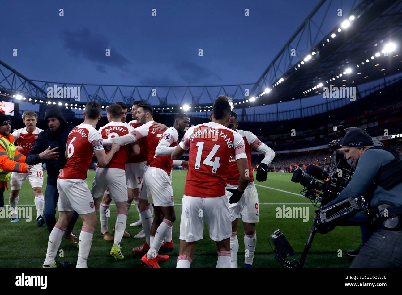 Arsenal players react as a pitch invader steps onto the pitch Stock ...