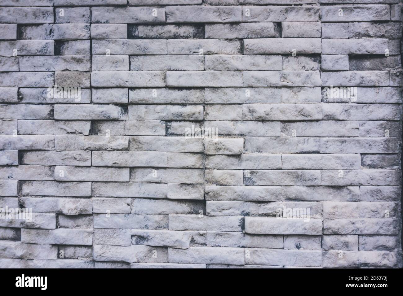 Close up of a gray brick wall texture for background. Weathered light ...