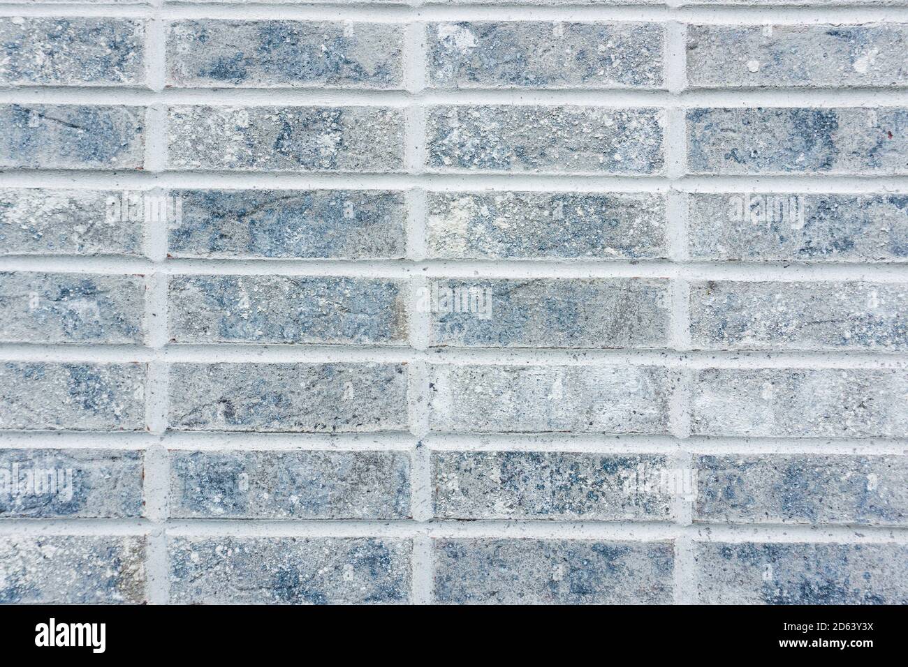 Close up of a gray brick wall texture for background. Weathered light ...